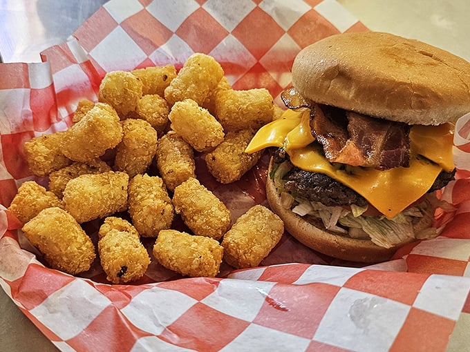 Bacon cheeseburger with a battalion of golden tater tots. This isn't just a meal&mdash;it's what happiness looks like on a red checkered paper.