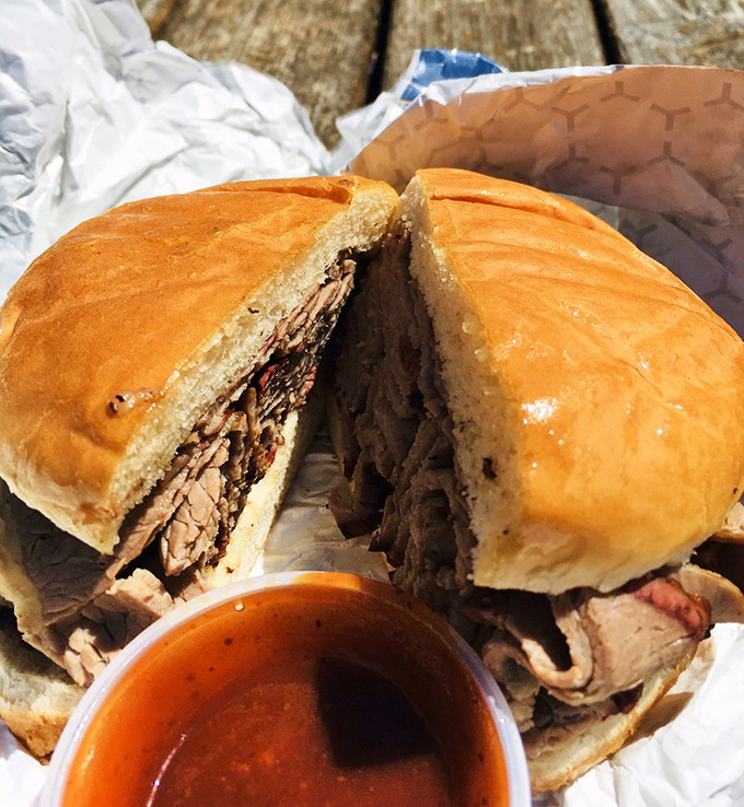 A brisket sandwich that makes all other sandwiches question their life choices. The sauce cup stands ready for those who dare to improve on perfection.
