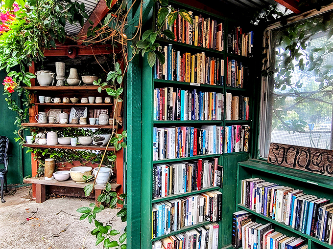 Ceramic cups share space with climbing vines, reminding visitors that books and beverages make the perfect companions in this verdant reading nook.