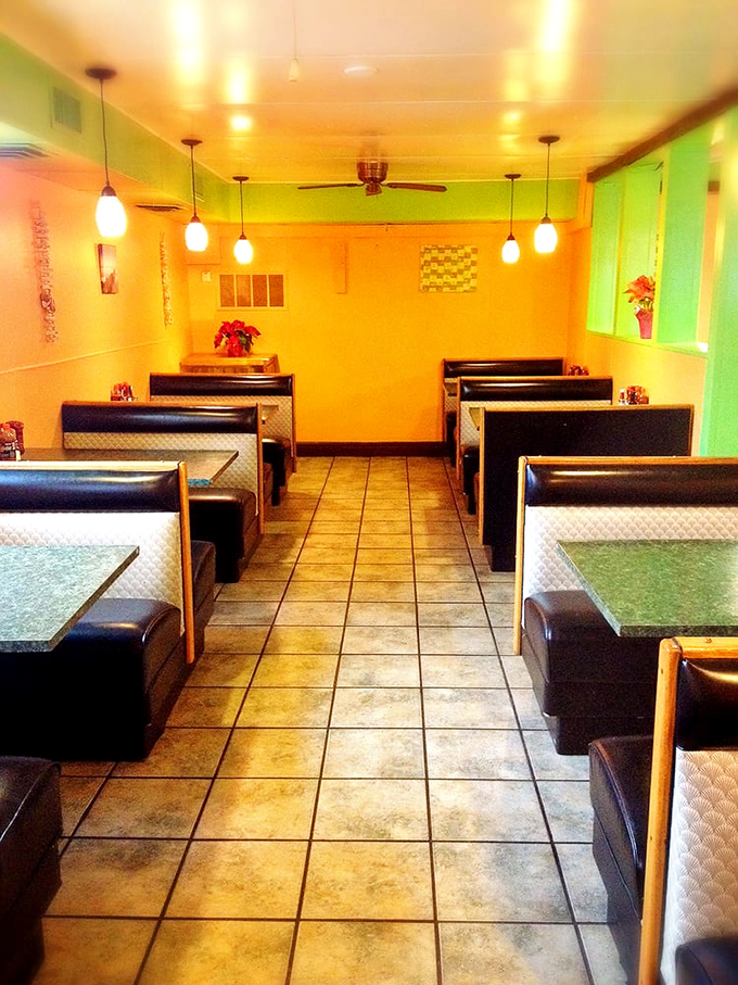 Sunshine yellow walls and cozy booths create a cheerful dining room that feels like a beachside café transported to the Midwest.