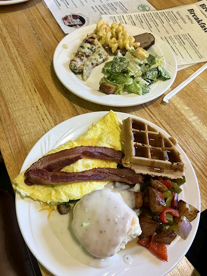 Breakfast that covers all bases: fluffy omelet, crispy bacon, golden waffle, and roasted potatoes. The morning grand slam we all deserve.
