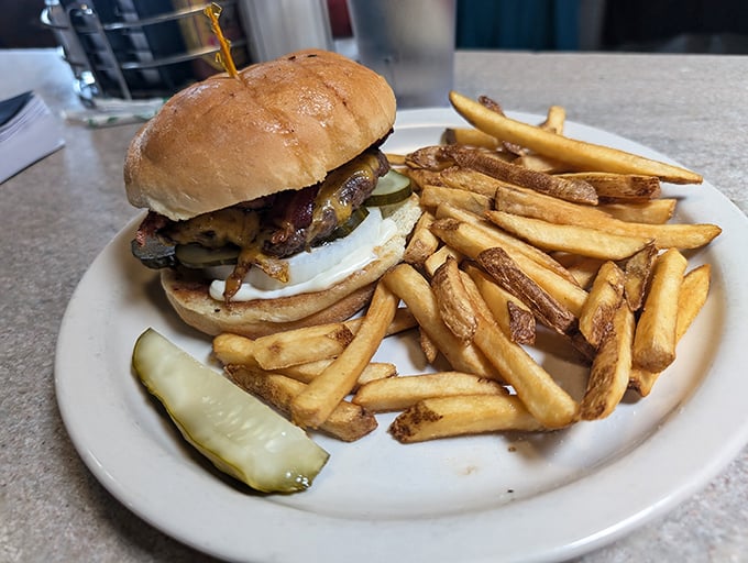 This isn't just a burger&mdash;it's an architectural achievement with a pickle garnish. Those hand-cut fries deserve their own fan club.