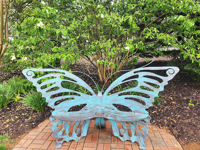 A butterfly bench that invites you to spread your wings while resting your feet. Metamorphosis optional, relaxation guaranteed.
