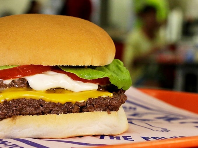 The perfect burger cross-section reveals the architectural genius behind Kewpee's creation&mdash;layers of flavor stacked with mathematical precision.