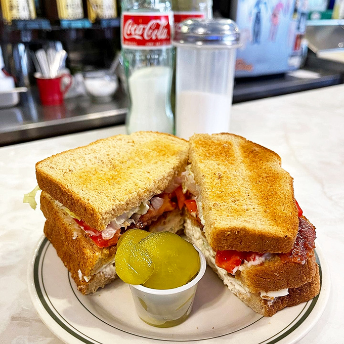 This isn't just a club sandwich&mdash;it's three stories of flavor architecture with a pickle foundation that deserves its own zip code.