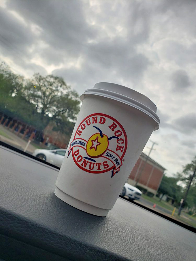 The perfect road trip companion: a steaming cup of Round Rock coffee, its logo promising the sweet adventures that await.