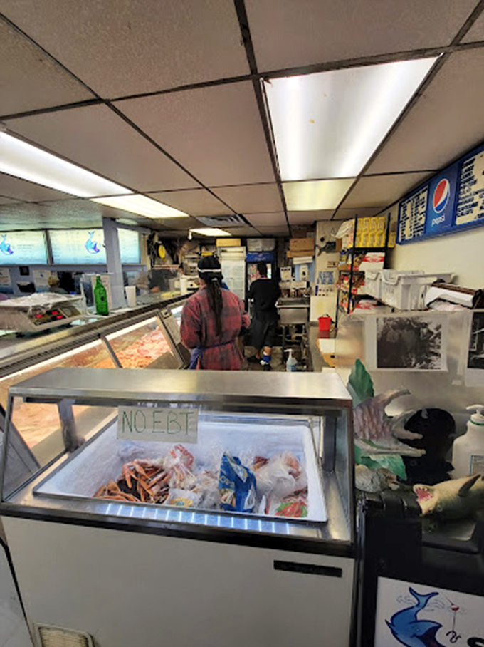 The quiet moment before the lunch rush&mdash;where fish meets fate and hungry customers contemplate the life-altering decision between catfish and buffalo fish.
