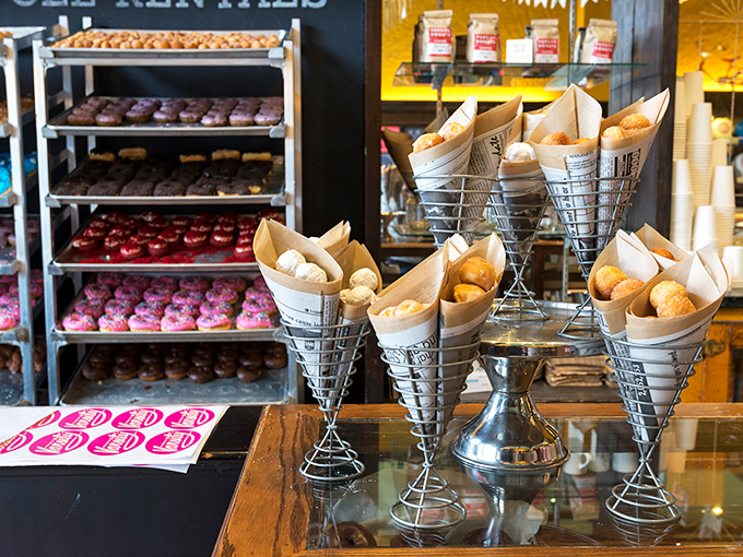 Donut holes nestled in paper cones await their fate. Like savory bouquets arranged for maximum temptation.