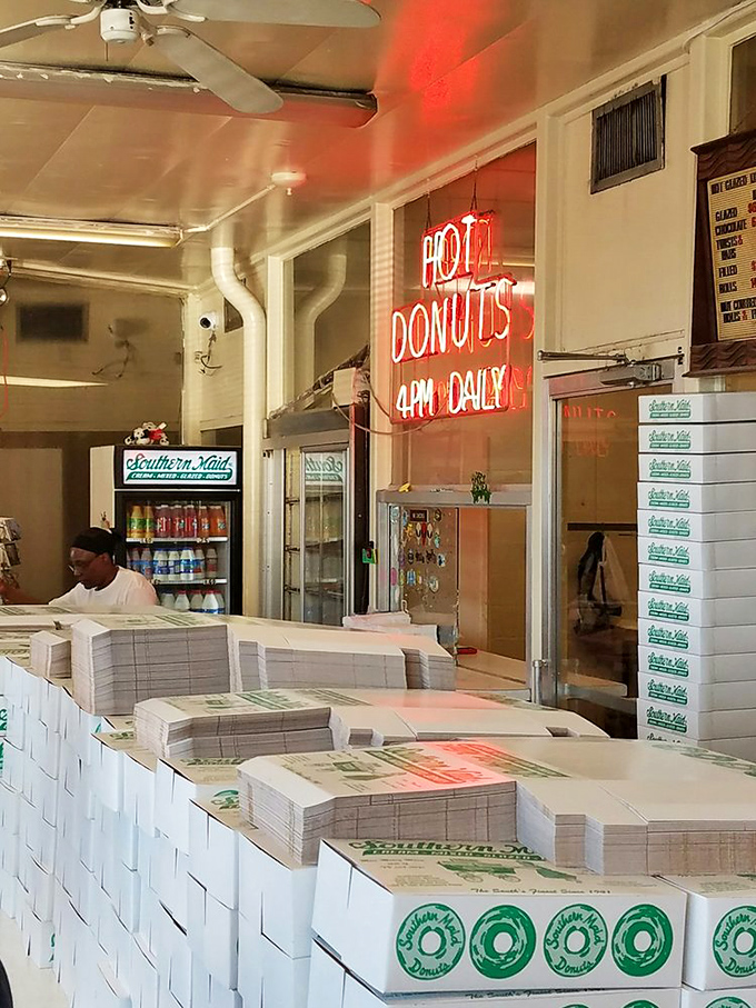 The tower of white boxes holds treasures more valuable than gold to those who know the true worth of handcrafted donuts.