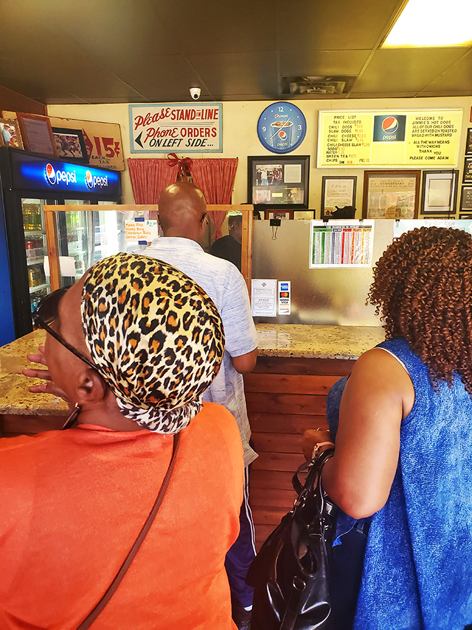 The line forms to the left, as instructed by the vintage sign. In the hot dog democracy of Jimmie's, everyone waits their turn.