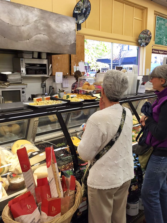 Classic diner ambiance with a dash of coastal charm &ndash; pendant lights, warm wood, and those signature red floral valances.