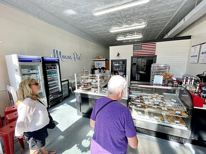 Pie pilgrims patiently await their turn at the display case, contemplating life's most important question: "How many slices is too many?"