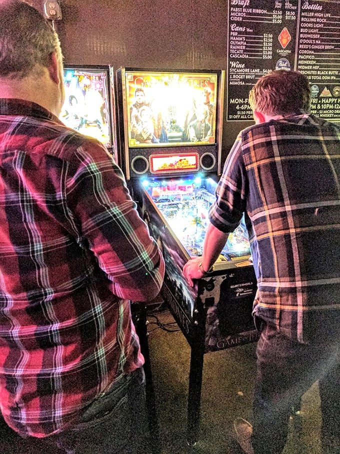 The pinball arena where hand-eye coordination reveals the true hierarchy among friends – personal scores inversely proportional to sobriety levels.