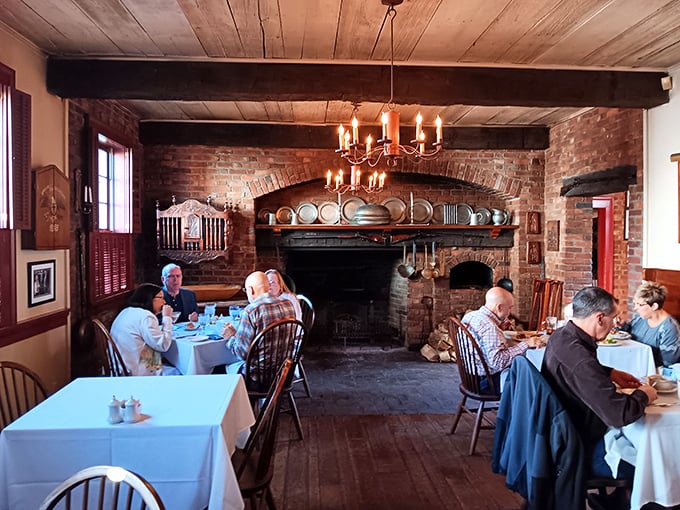 The fireplace isn't just for warmth—it's the heart of this dining room where modern conversations echo those from two centuries ago.