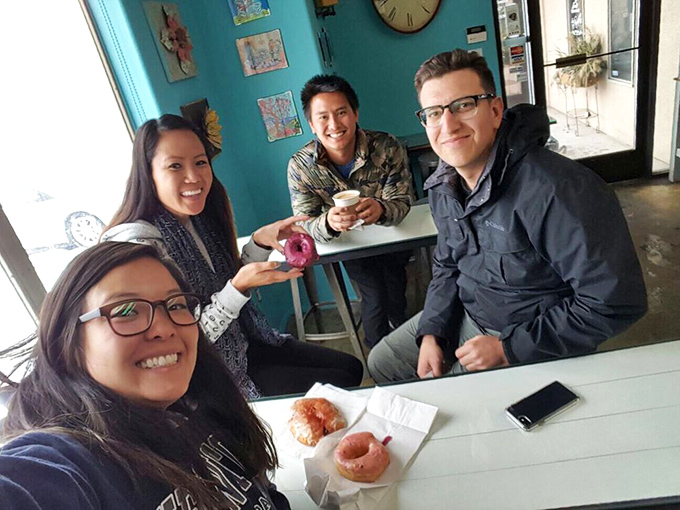 Donut diplomacy in action! Nothing brings friends together like shared sugar experiences and that unmistakable look of "I can't believe how good this is."