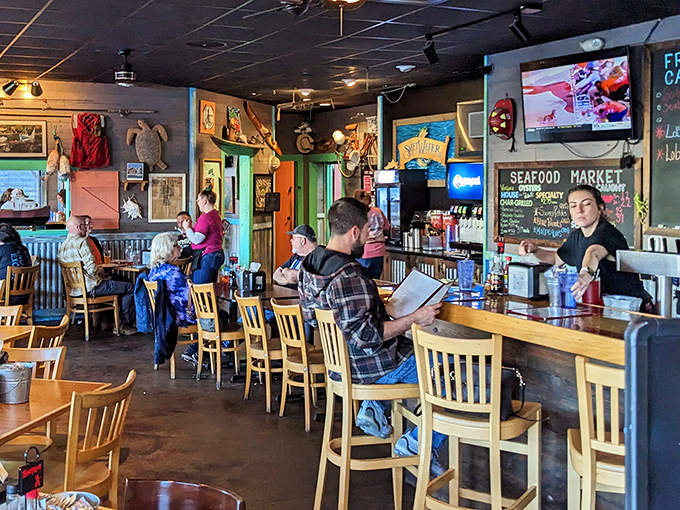 The bar buzzes with locals and visitors alike &ndash; all united in the universal language of "pass the tartar sauce" and "order another round."