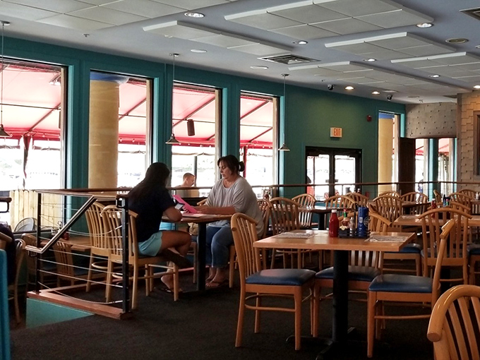 The multi-level dining room offers both intimacy and space. Those wooden chairs have supported generations of satisfied seafood enthusiasts.