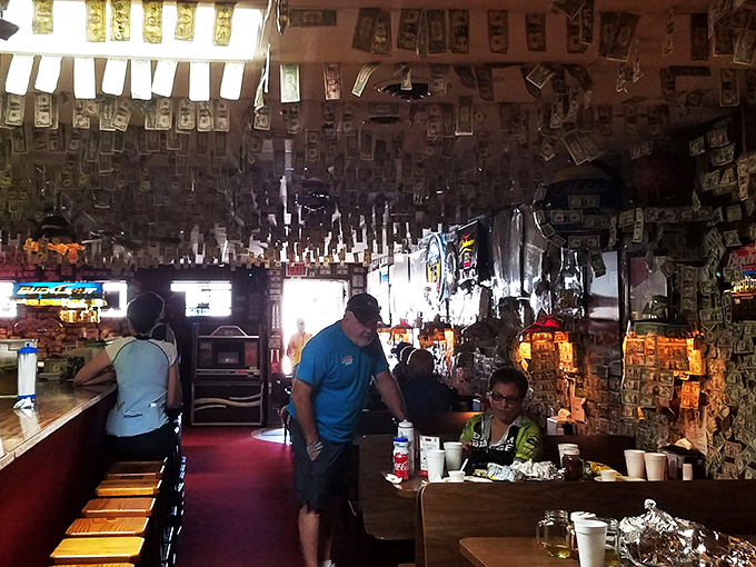 Strangers become friends over shared tables and sauce-stained fingers. The universal language of great barbecue brings people together under a ceiling of dollar bills.