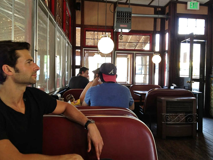 The universal expression of anticipation. These diners know they're moments away from cheesesteak nirvana.