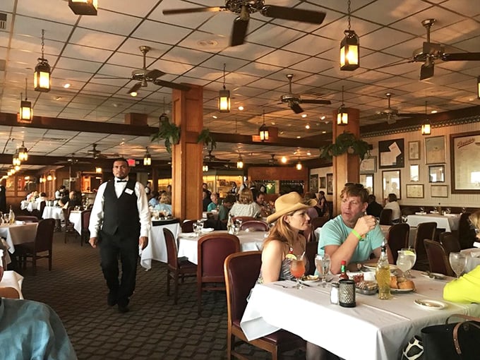 Servers glide between tables with practiced grace while diners lean in, sharing stories as essential to the meal as the seafood itself.