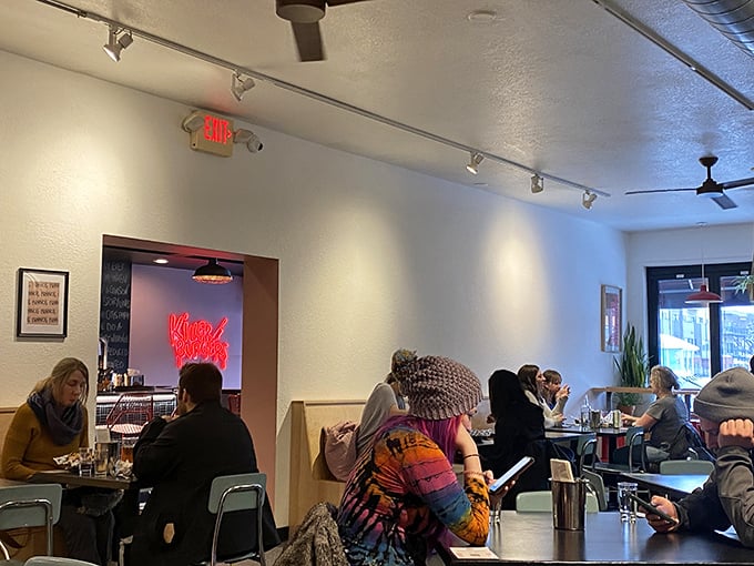 The universal language of good food brings strangers together in a space where burger anticipation fills the air.