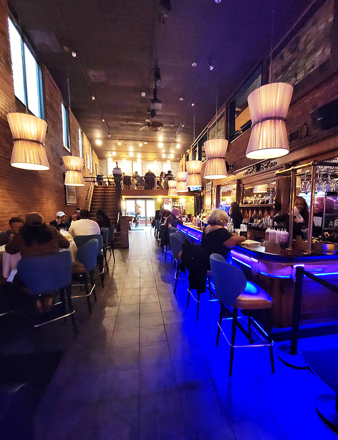 The vibrant bar scene feels like a neighborhood party where everyone's waiting for their invitation to the kitchen.