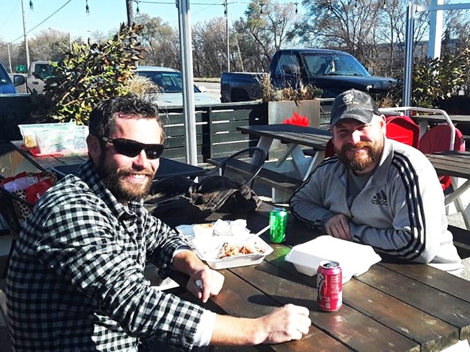 The universal language of barbecue: two friends, foam containers, and the satisfied silence that comes with exceptional eating.