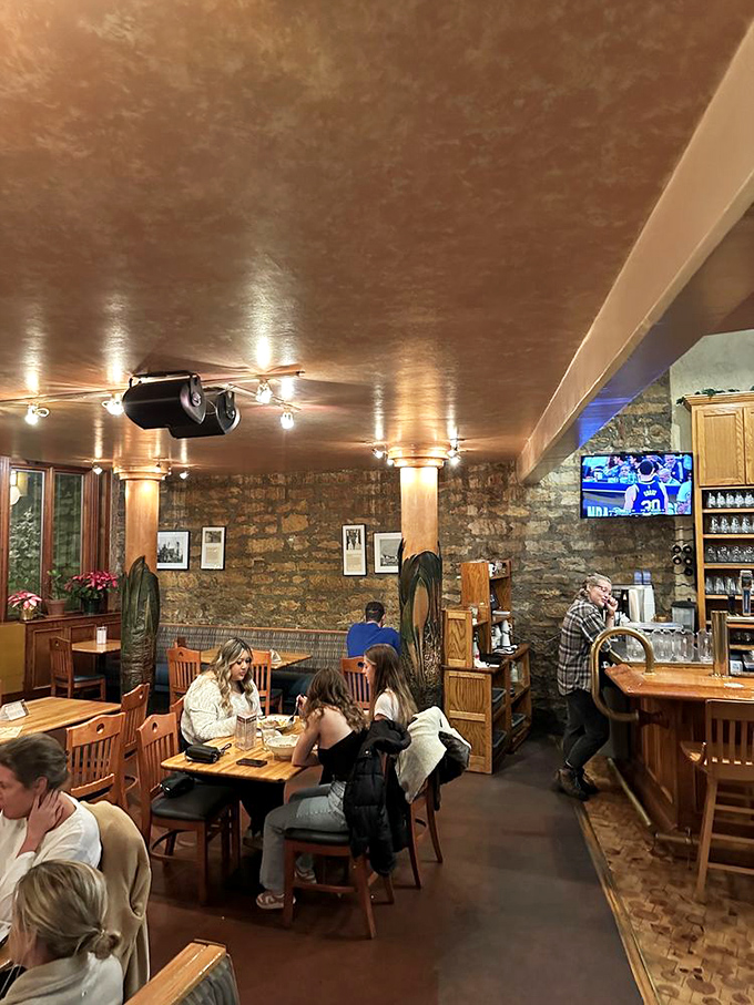 The universal language of good food bringing strangers together under exposed beams and warm lighting. Community in a nutshell.