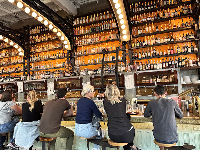 The backlit bar showcases enough spirits to satisfy a thirsty crew of sailors after months at sea.