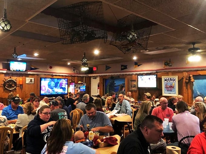 The casual riverfront bar fills with locals and visitors alike, proving that great food and waterfront views are the universal language of weekend happiness.