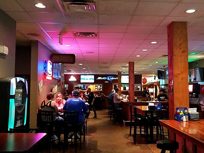 Where strangers become friends over shared BBQ enthusiasm. The neon glow adds a touch of dive bar charm to meat-eating paradise.