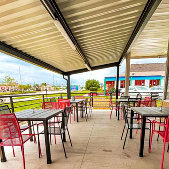 The covered patio offers a perfect perch for savoring your Mexican feast. Red chairs pop against the simple backdrop, like salsa on a fresh taco.