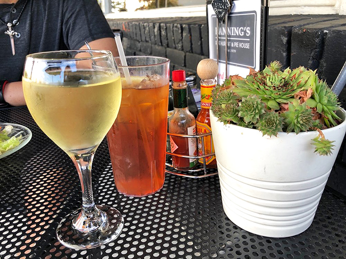 Patio drinks at Banning's—where wine glasses and iced tea coexist peacefully under Oregon skies. The succulent centerpiece is just showing off.