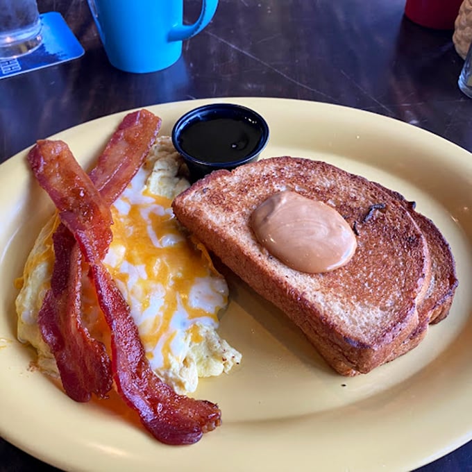 Breakfast fundamentals executed flawlessly: crispy-edged eggs, bacon with the perfect bend, and toast that's ready for its close-up.