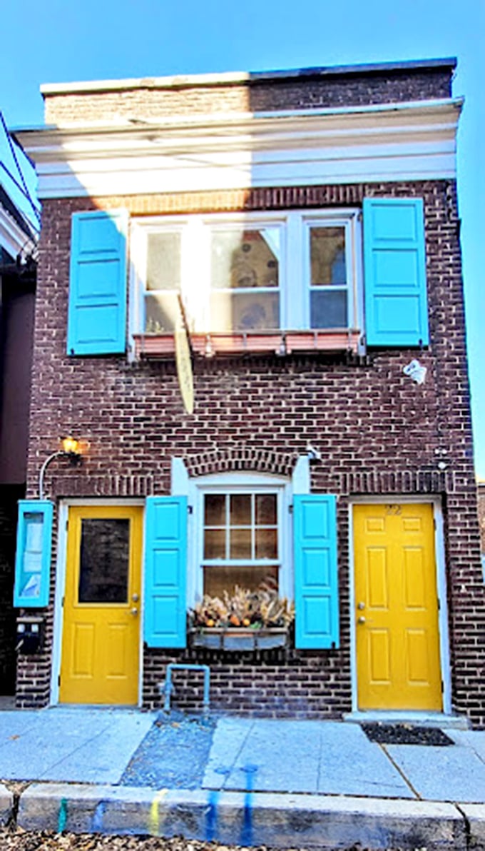 The cheerful yellow doors and turquoise shutters of Moya's facade are like the town's colorful personality distilled into architectural form.