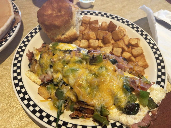 This omelet has more fillings than my tax return, served alongside home fries that achieve that perfect crisp-tender harmony.