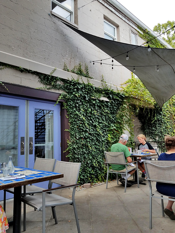 The ivy-covered patio feels like dining in a secret garden where even the simplest meal becomes an enchanted experience.