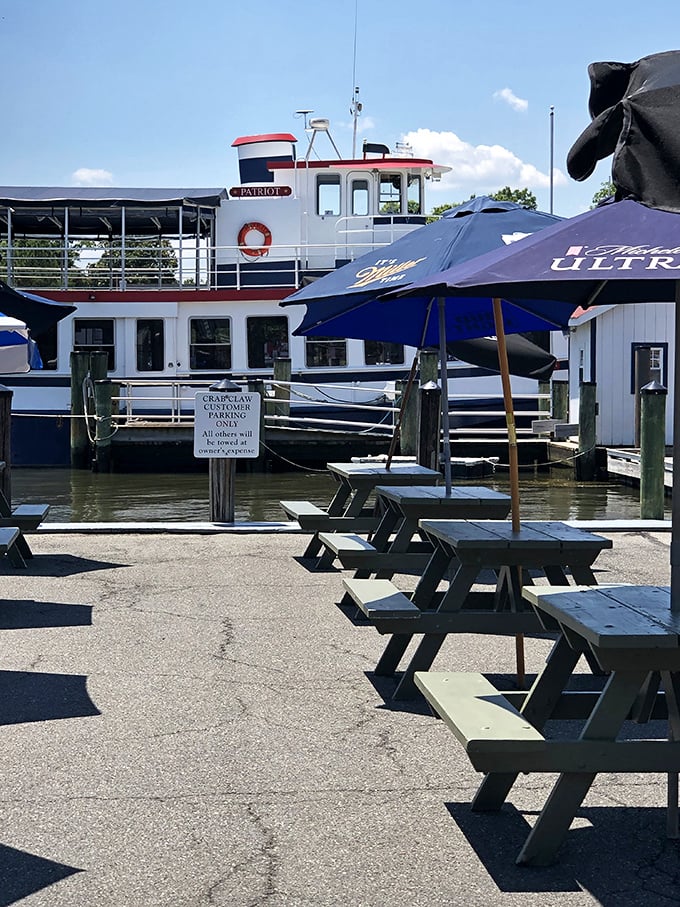 The Patriot cruise ship docks near The Crab Claw's outdoor seating, where picnic tables await the next wave of hungry explorers.