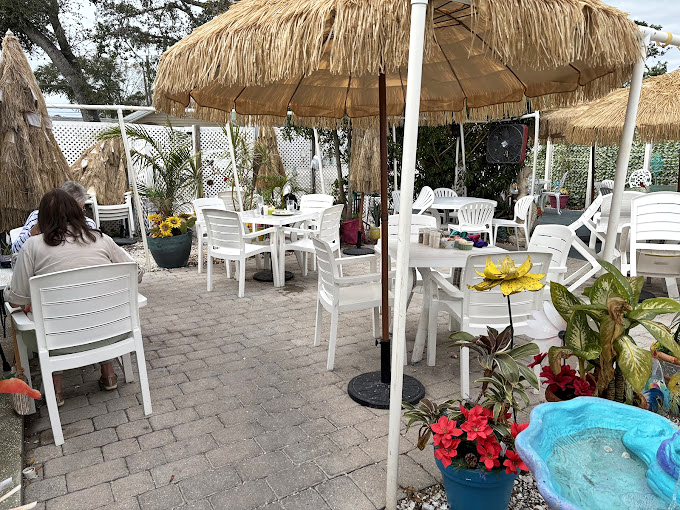 Tiki umbrellas and garden seating create the perfect "I'm on vacation even though I live here" vibe for your morning coffee ritual.