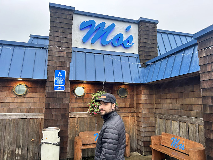 The blue Mo's sign stands as a coastal lighthouse for the hungry, guiding travelers to chowder salvation since before Instagram existed.