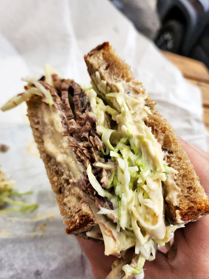 This pastrami sandwich has more layers than a Shakespearean plot. The marriage of meat and bread achieving perfect harmony.