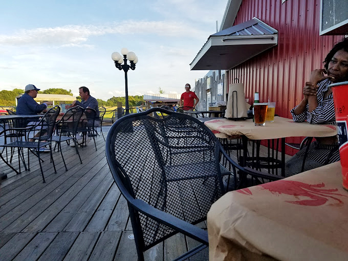 Sunset conversations on the deck, where strangers become friends over shared love of perfectly prepared seafood and cold beer.