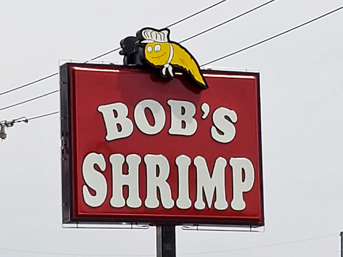 That cheerful shrimp mascot atop the roadside sign has guided hungry travelers to flavor paradise for generations.