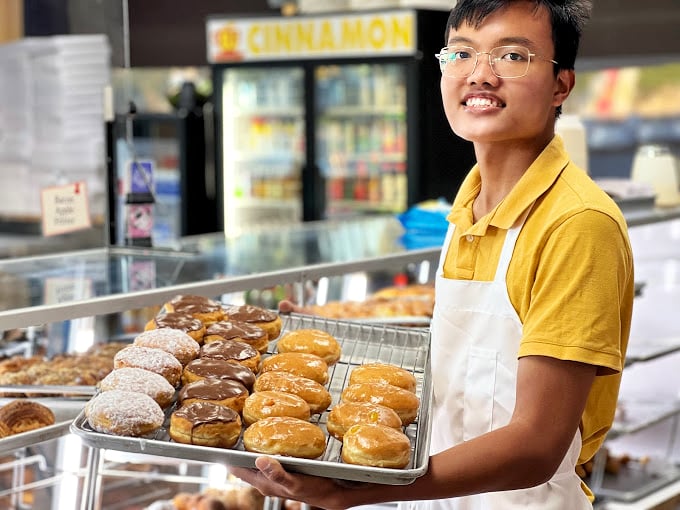 Behind every great bakery is a dedicated team crafting joy from flour and sugar. That smile says it all&mdash;pastry pride is real.