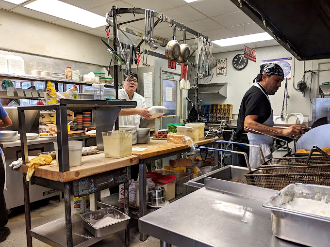The kitchen crew moves with the choreographed precision that comes only from years of practice and thousands of perfectly flipped eggs.