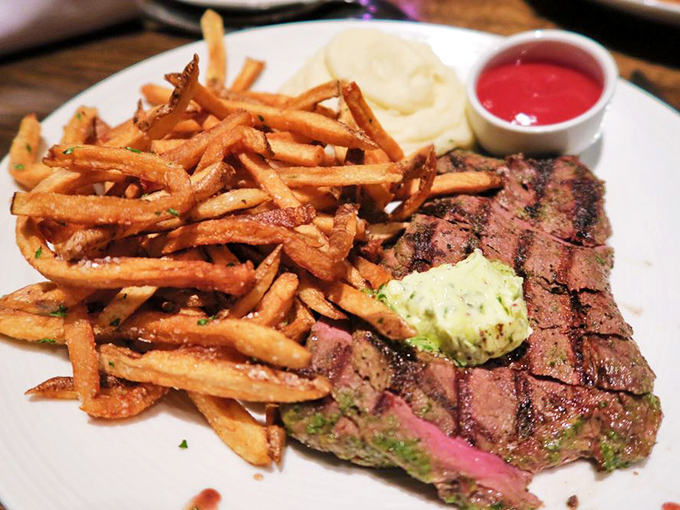A perfectly seared steak with a pat of herb butter slowly melting into its rosy interior&mdash;carnivore poetry on a plate. 