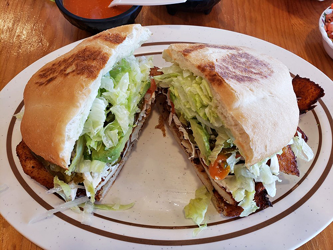 This torta is what happens when a sandwich decides to live its best life&mdash;crispy bread, fresh lettuce, and savory fillings in perfect harmony.