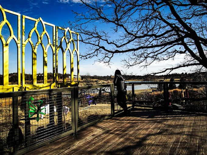 Yellow architectural elements frame the landscape like living paintings, offering visitors a new perspective on the rolling Oklahoma hills beyond.