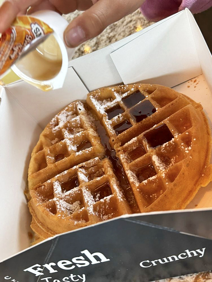 A waffle so perfect, with those little squares catching syrup like nature's own honey traps. Breakfast architecture at its finest.