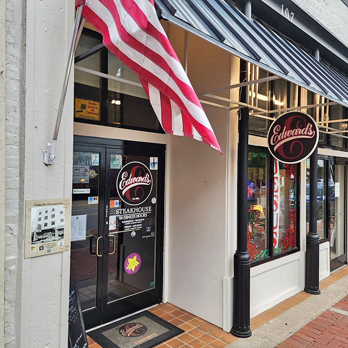 The American flag flies proudly outside Edward's Steakhouse, where patriotic duty includes consuming perfectly prepared beef in historic surroundings.